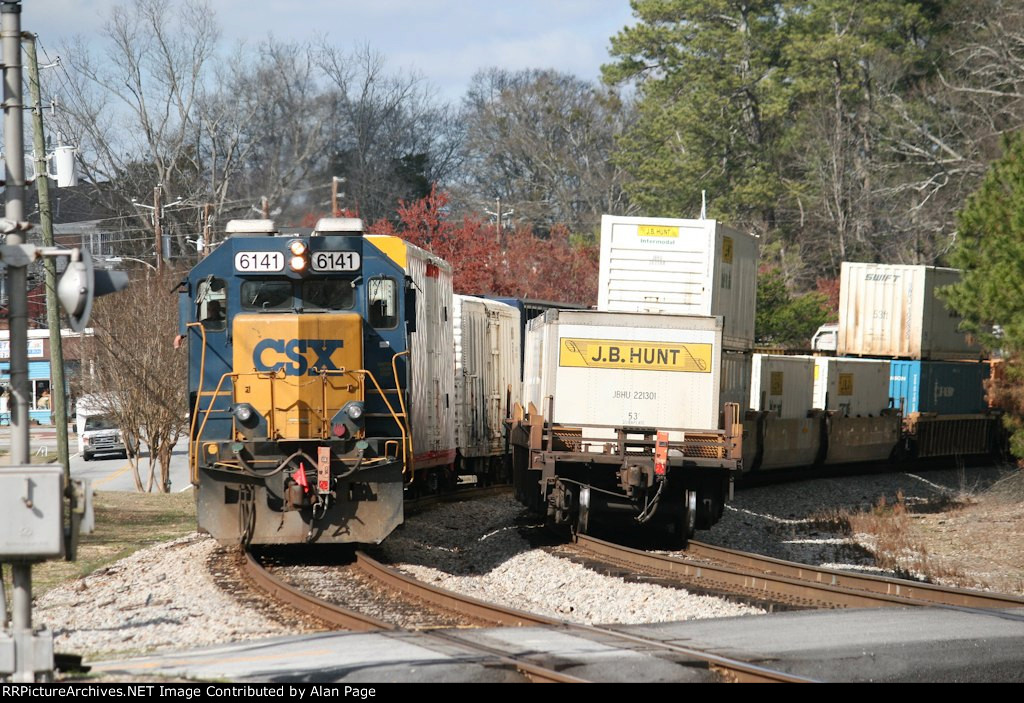CSX 6141 waits for green as NB containers pass